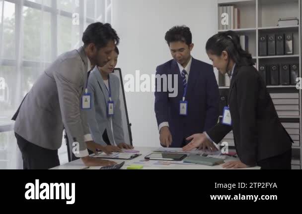 Successful asian business team handshake celebrating good job while shaking hands in meeting and ...