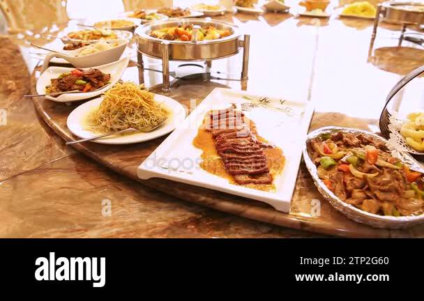 Chinese restaurant in the hotel. Round table with twisting dishes of ...