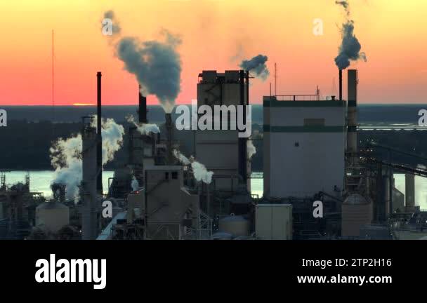 Huge factory with high chimneys polluting atmosphere with carbon ...