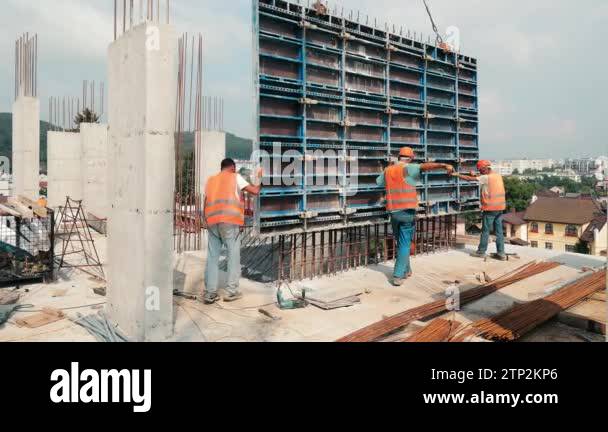 Builders install a large metal structure for pouring monolith ...