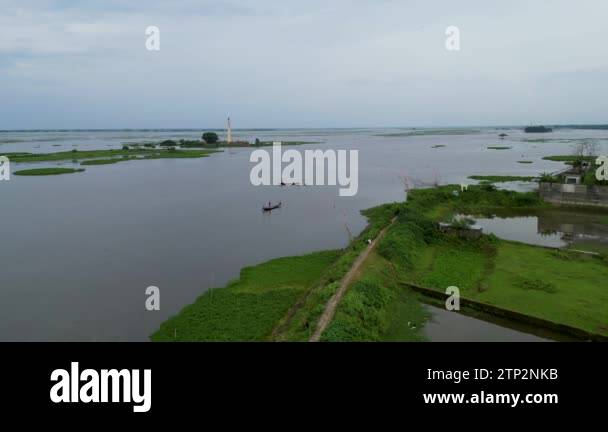 a Titas river with a boat in it, boat is in the middle of a river ...