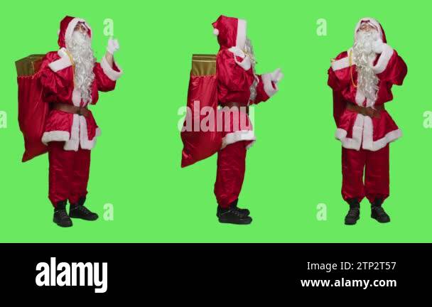 Father christmas gives thumbs up in studio, feeling cheerful showing ...