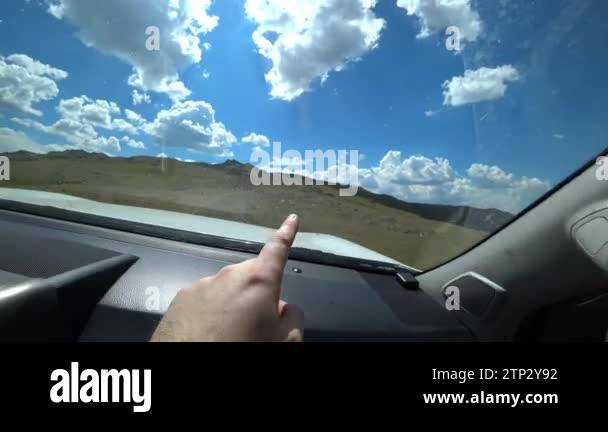 Drive an SUV through the hills of the mountains. A white car drives ...