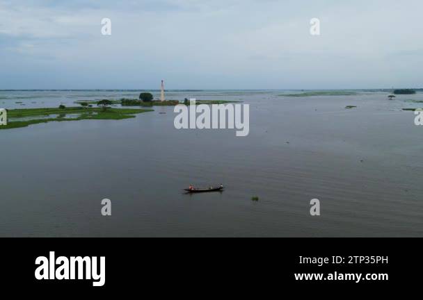 a Titas river with a boat in it, boat is in the middle of a river ...
