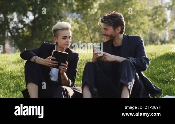 Team building two colleagues in park. Man with girl wear suits outside ...