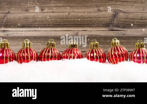 Still life with red ball row in snowfall being covered with snow ...