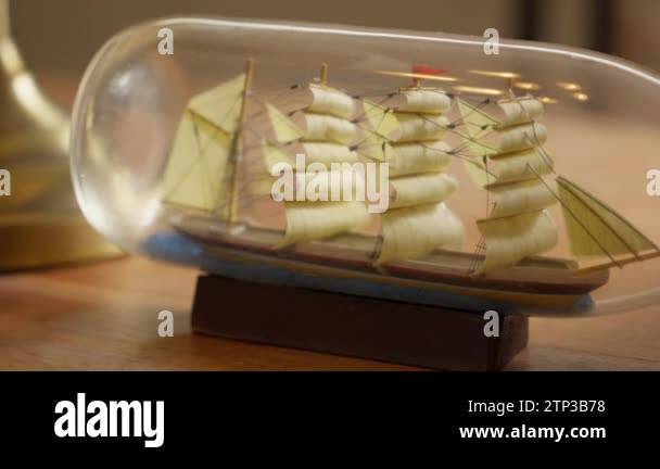 An intricate masterpiece captured within a glass bottle a sailboat ...