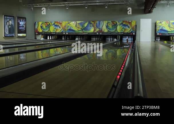 People playing a game of bowling at the small town bowling alley in ...