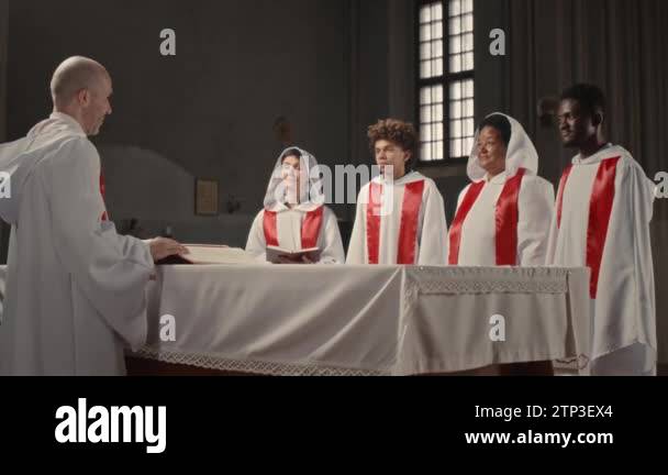 Middle aged bald headed Caucasian conductor and other diverse members ...