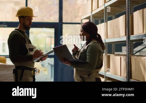 Head of logistics and worker perform warehouse inventory controls ...