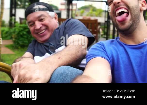 Dad and son playing on roundabout Stock Video Footage - Alamy