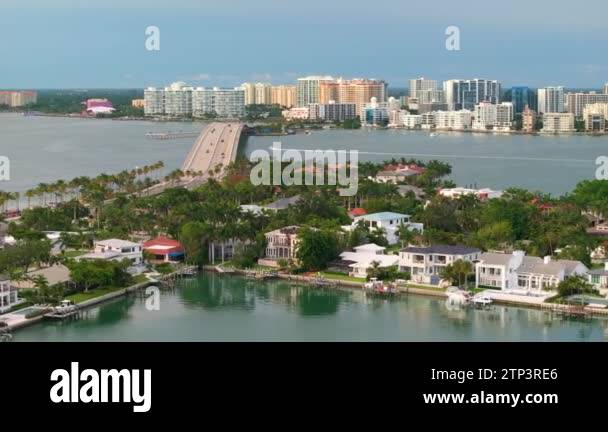 Rich neighborhood on Bird Key with waterfront houses between green palm ...