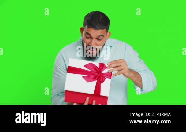 Happy Indian man opening birthday gift box with red ribbon. Holidays ...