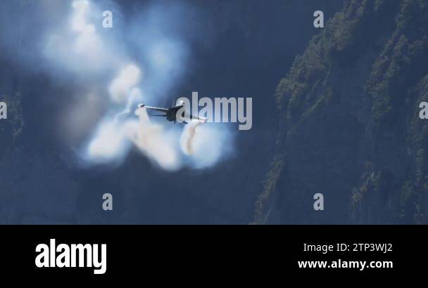 High-performance fighter jet simulates combat maneuvers in a narrow ...