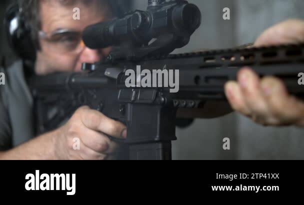 Firing an Assault rifle in super slow-motion 800 fps. Person shooting ...