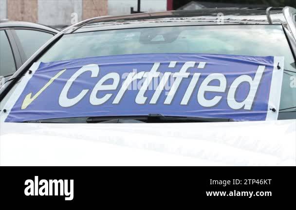 certified word text sign banner flag on front of black car vehicle ...