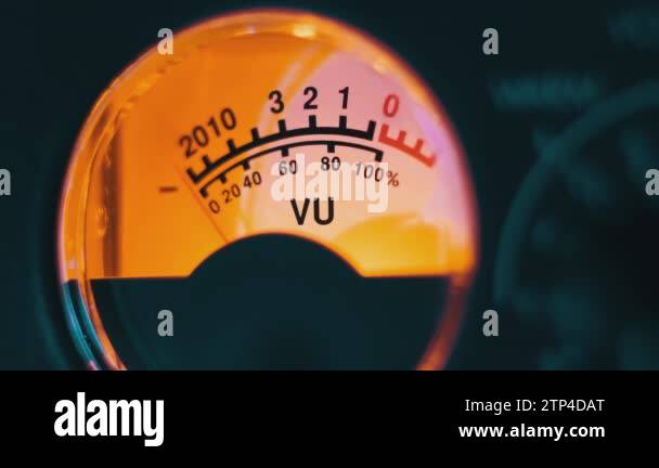 Analog dial indicator of audio signal level. Vintage arrow moves in ...