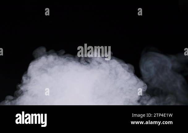Jet stream of smoke or vapor on black background in slow motion 4K ...