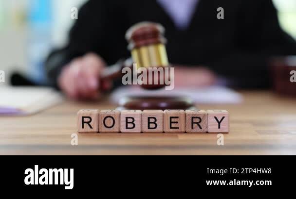 Word Robbery made of cubes against female judge knocking wooden gavel ...
