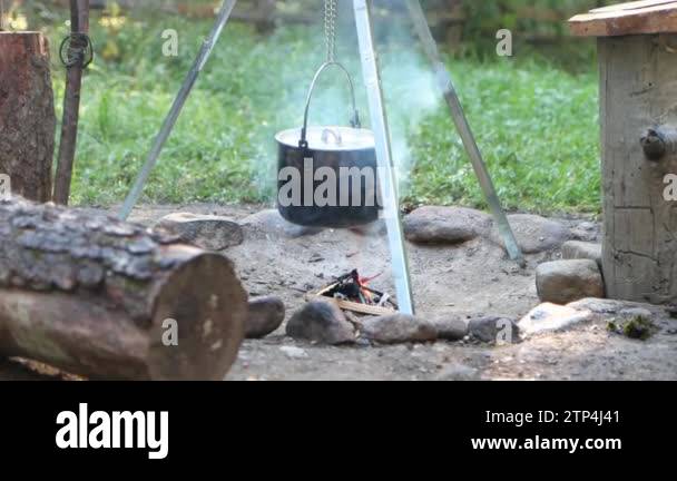 Cooking food in nature. The pot is hanging over the fire, no people 4K ...