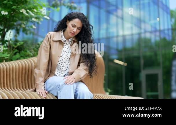 Young female employee suffers from painful severe knee joint pain while ...