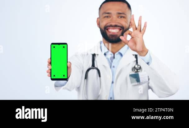 Doctor, phone green screen and like, thumbs up or ok hands for ...
