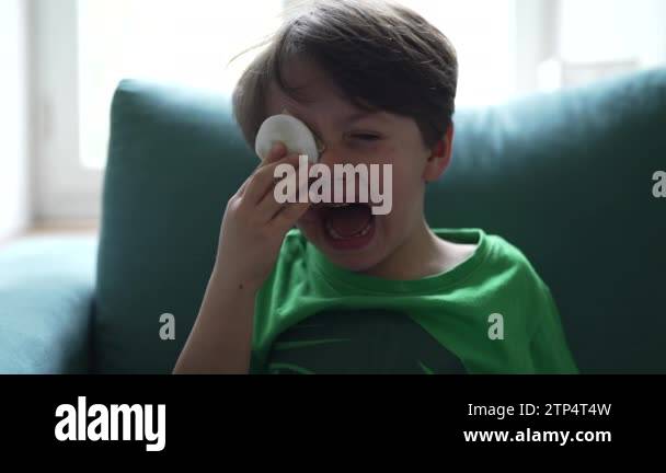 Crying small boy with hurt eye emergency, open mouth tearful child ...