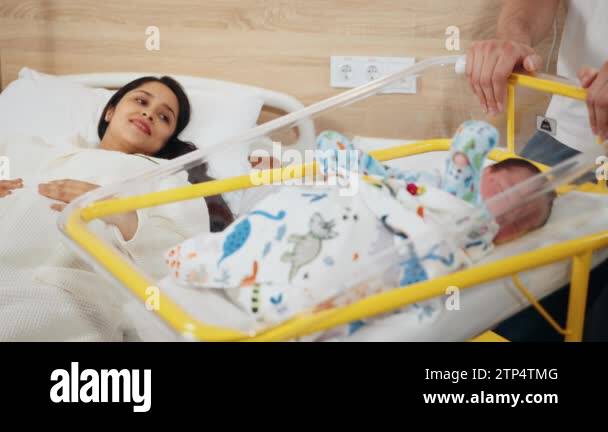 Happy mexican woman after cesarean lying on bed in post natal hospital ...