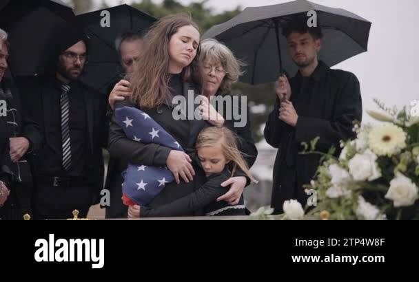 Funeral, family hug and sad people with grief support, goodbye service ...