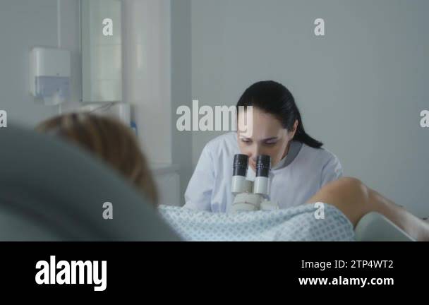 Gynecology room in modern hospital. Female doctor uses colposcope ...