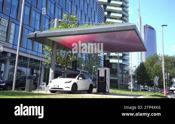 Europe, Italy, Milan 08-25-23 - Tesla electric car is charging the ...
