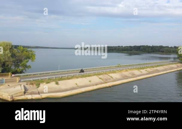 Man riding on modern motorbike at dam route on summer day. Motorcyclist ...