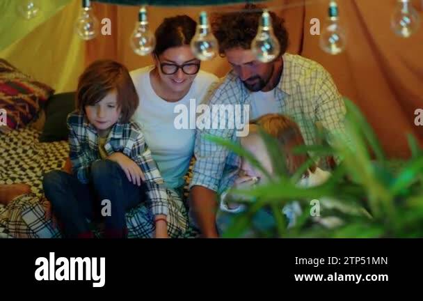 Young parents spending time with their kids while sitting inside the ...