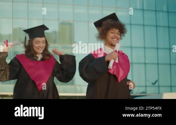 Two Positive Successful Graduates Dancing With Diplomas Near College ...