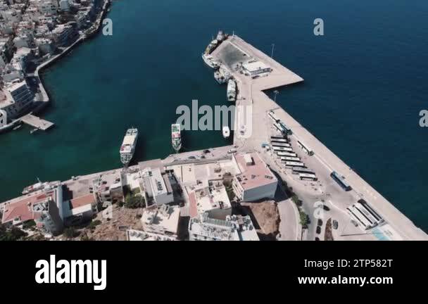 Beautiful sunshine shining over the city of Agios Nikolaos. Build up ...