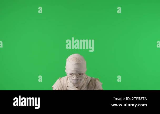 Green screen isolated chroma key video capturing a mummy shaking its ...