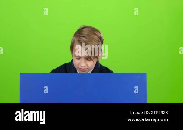 Child boy appeared from behind a blue poster to look at him shows like ...