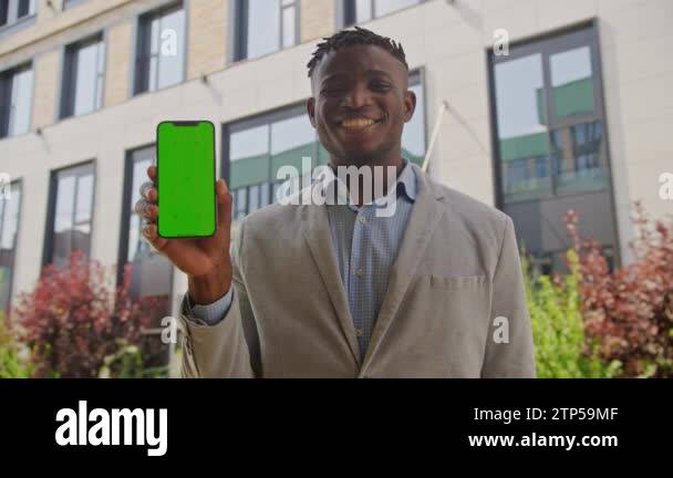 Black Man Holding Green Screen Cell Phone Looking at Camera. African ...