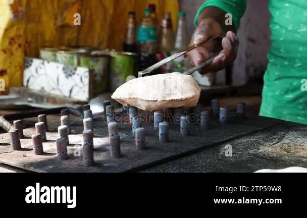 Man cooking Indian flat bread, called chapati roti naan paratha and ...