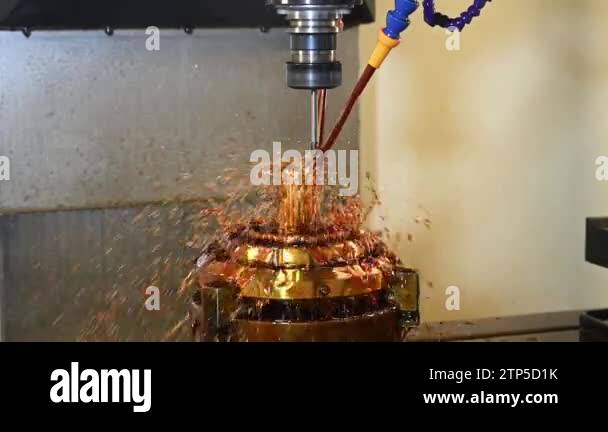 The CNC milling machine cutting the shell mold parts with oil coolant ...