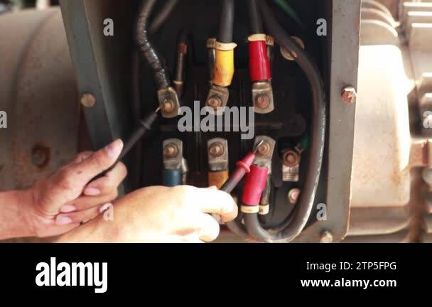 Stop checking the motor repairs : Closeup male electrician worker uses ...