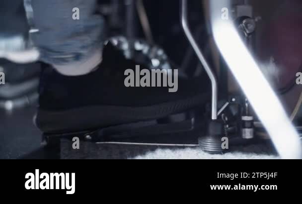 Body part of crop faceless male drummer tapping on bass drum pedal and ...