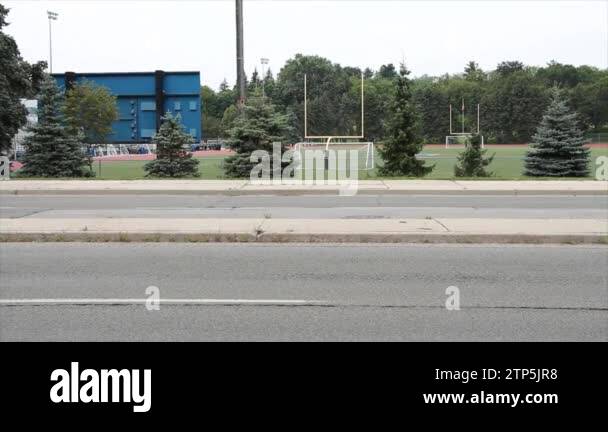 football soccer stadium field track shot from across road street with ...