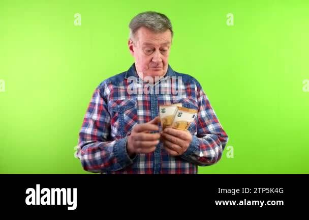 Senior man counting cash of 50 euro money banknotes and smiling pleased ...