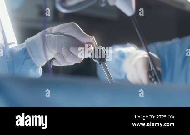 Hands close up of professional surgeons performing operation using ...