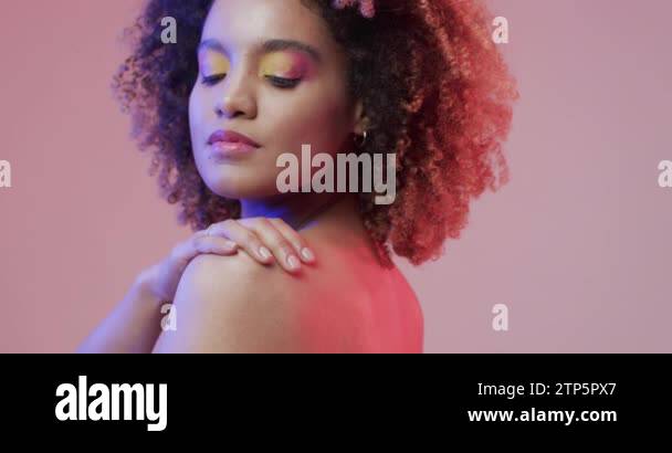 Biracial woman with dark hair on purple background, slow motion ...