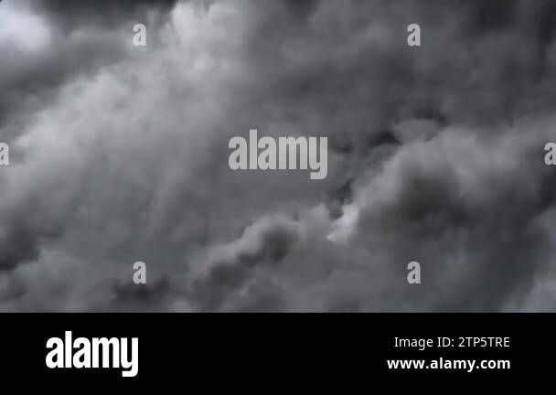 Terrible cumulonimbus thunderclouds. Weather alarm. Impending danger. Gray and black ragged ...