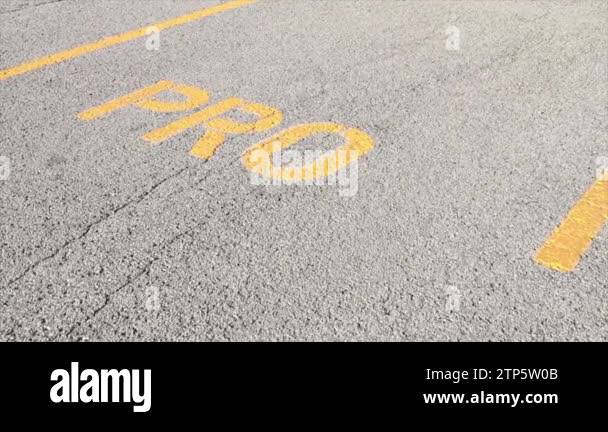parking space in parking lot that says pro in yellow capital letters ...