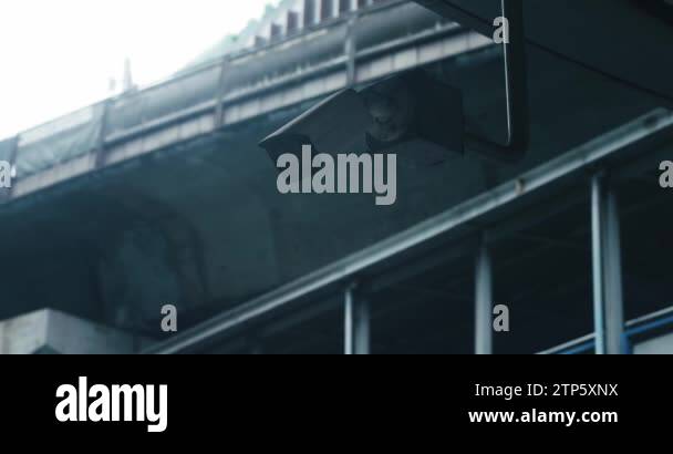 Cctv camera security system scanning street in big city buildings ...