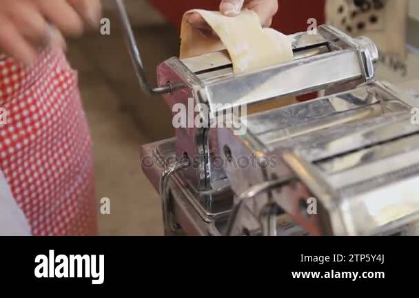 Making spaghetti with a traditional style pasta machine. Cooking ...